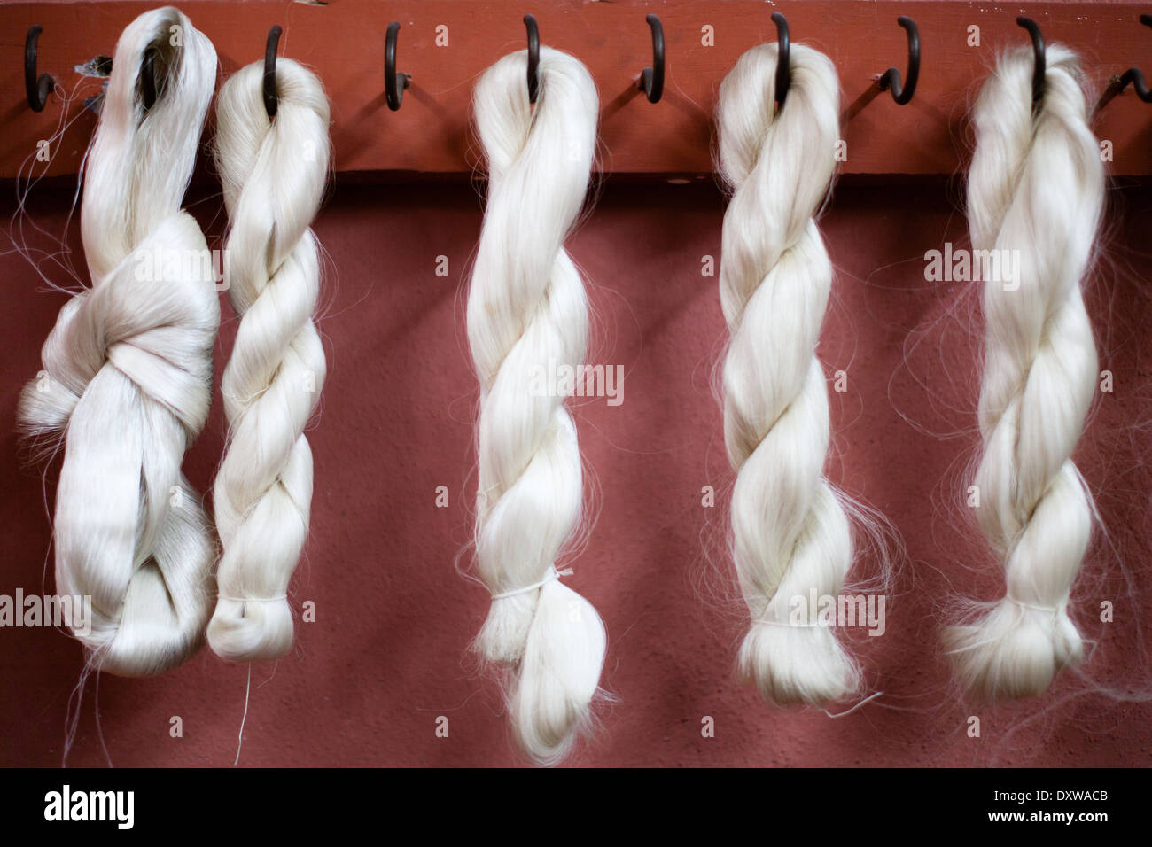 Raw silk plait hanging on the wall Stock Photo - Alamy