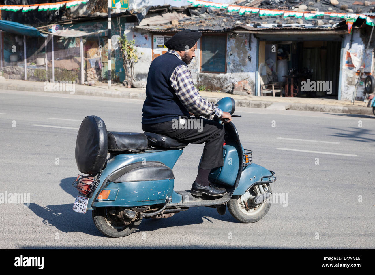 India, Dehradun. A Sikh Man Riding a Motorbike--Wearing a Turban but no ...