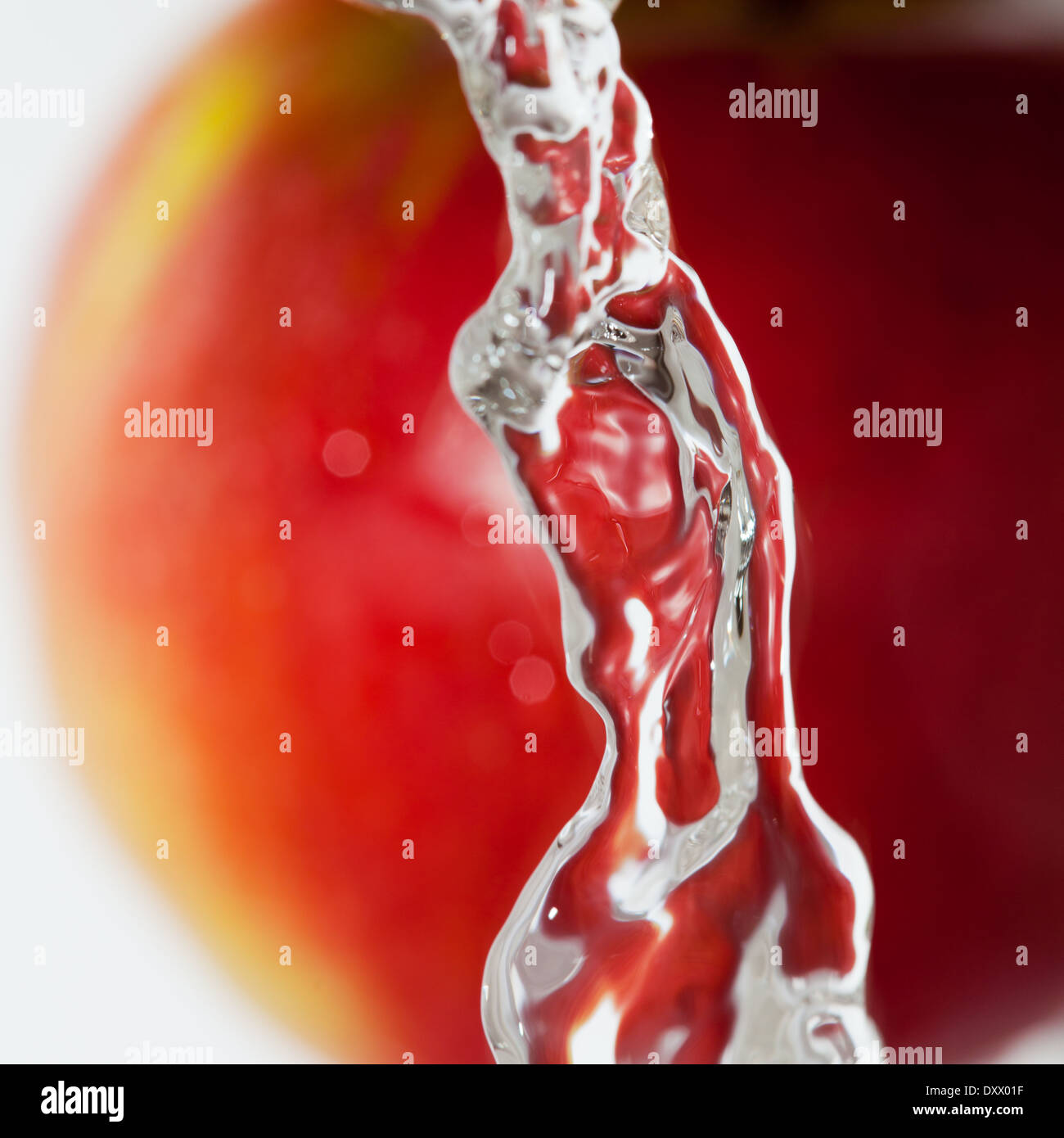 washing apple - red apple being washed under a jet of water, frozen ...