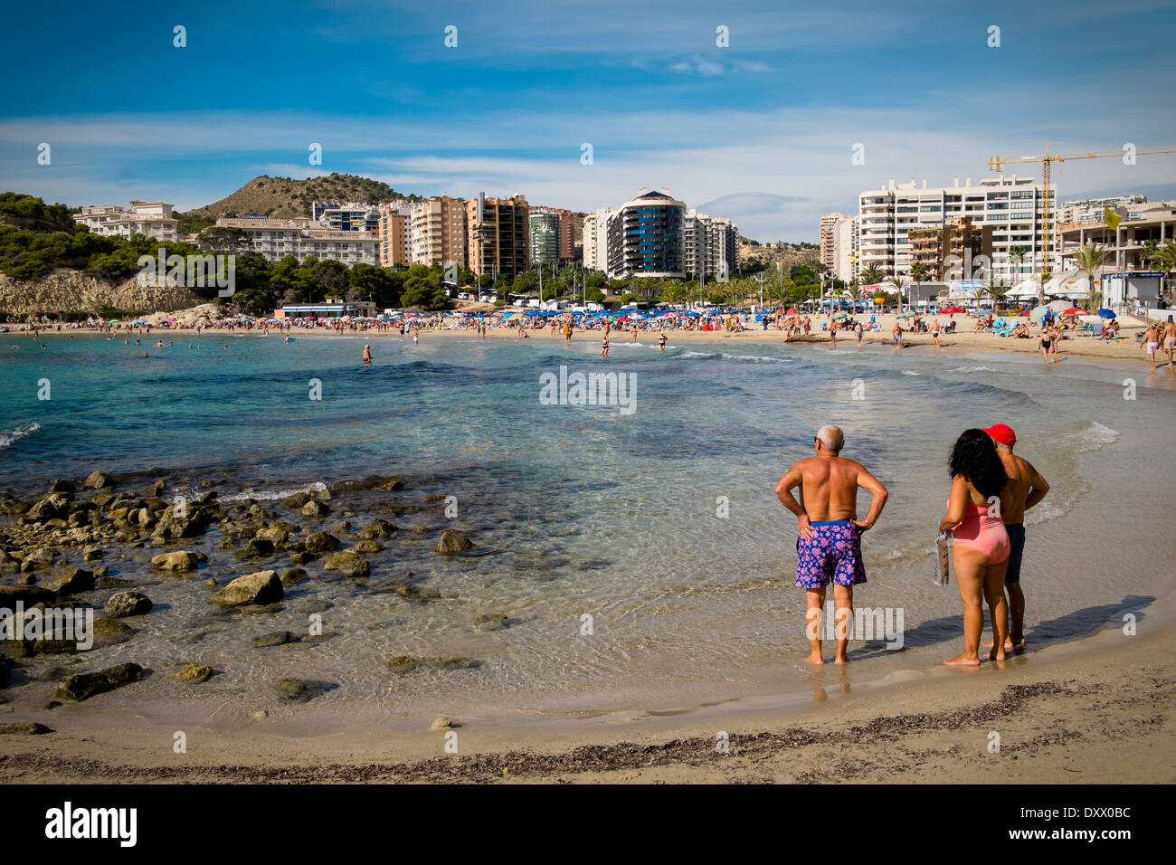 three holidaymakers on Cala Finestrat beach on the Costa Blanca Stock ...