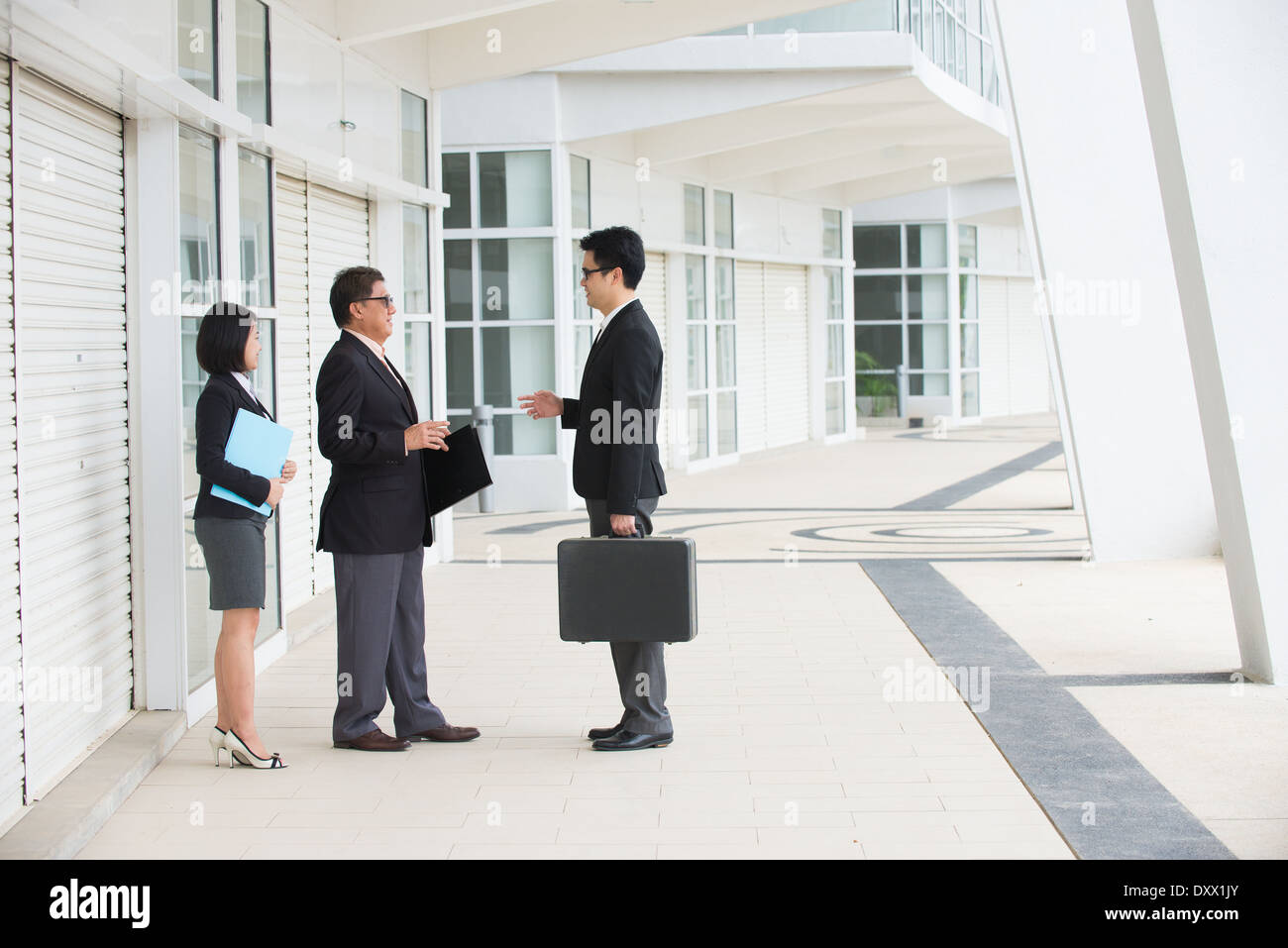 asian business team meeting with senior ceo with office background ...