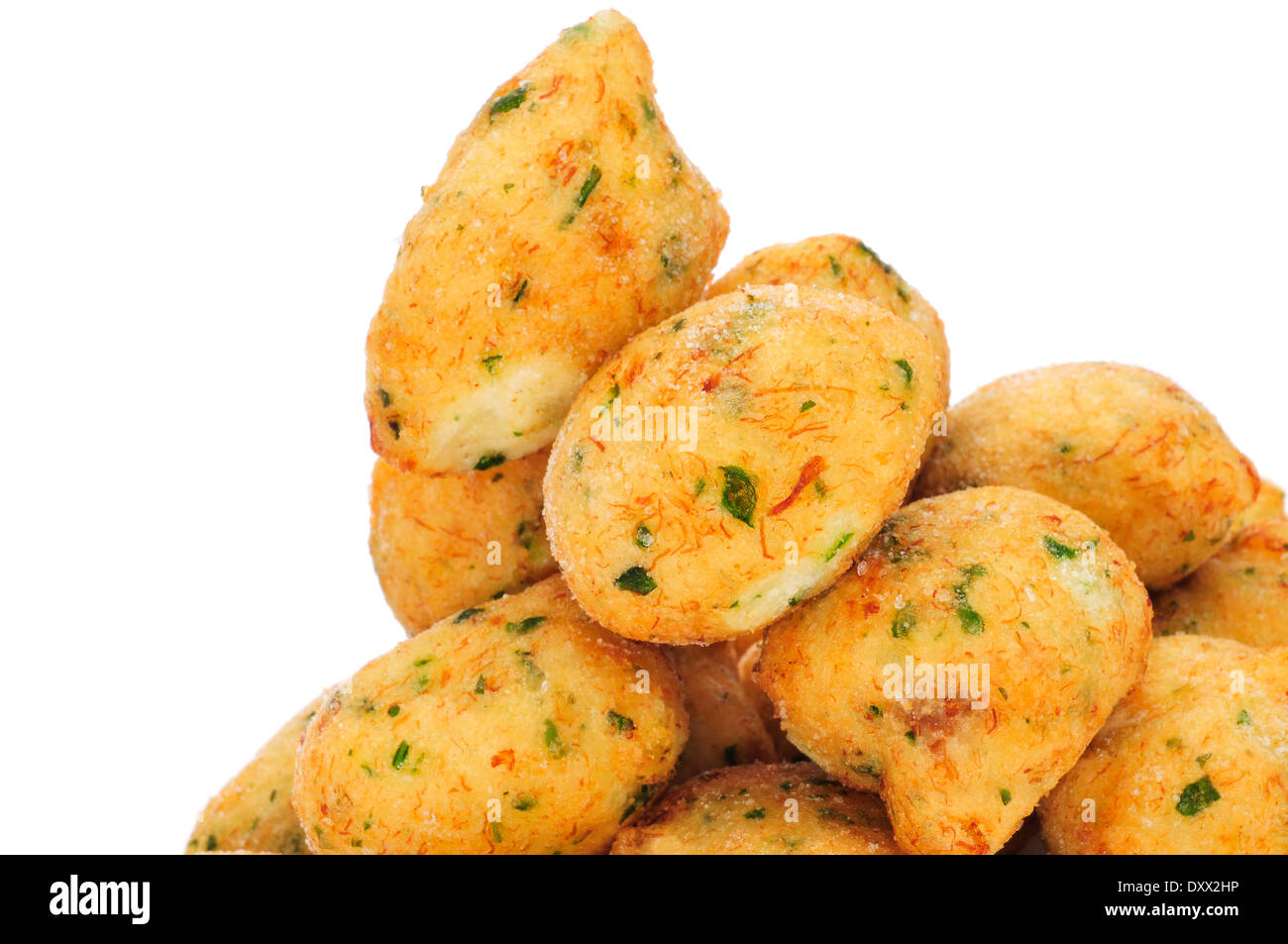 a pile of bunuelos de bacalao, spanish cod fritters, on a white ...
