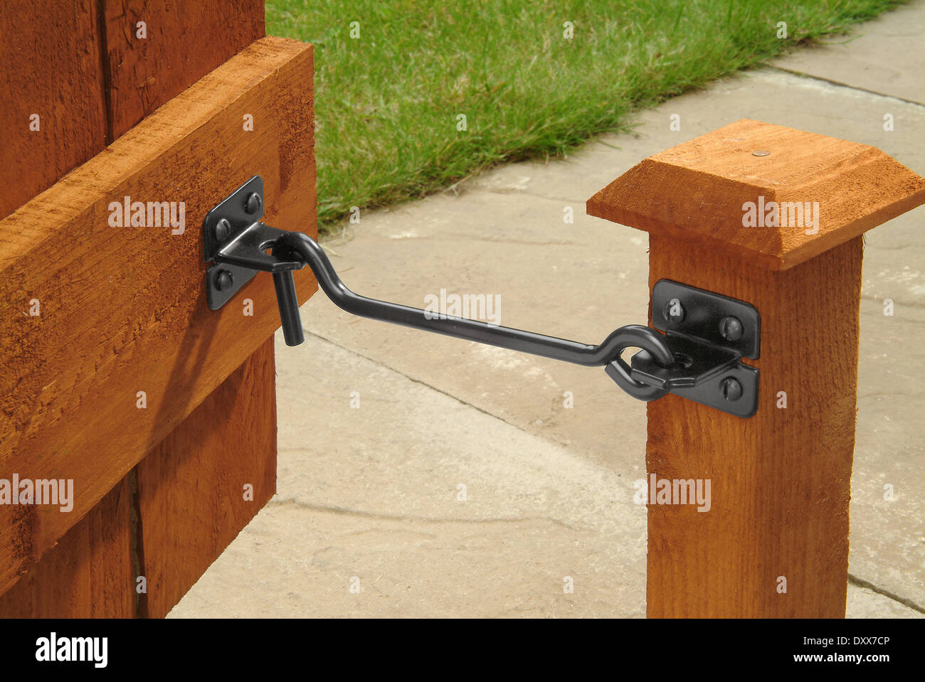 Hook and eye on garden gate with grass and path in background Stock ...