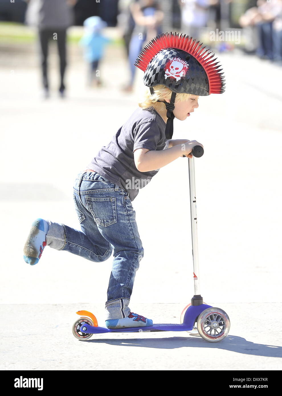Zuma Rossdale wearing a 'mohawk' helmet while riding his scooter at a ...