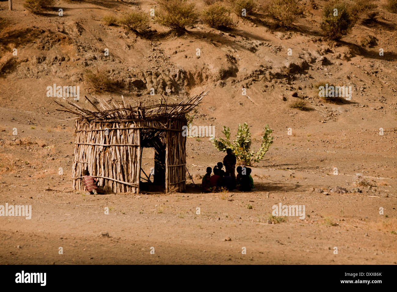 African men sat in shade of hut next to dusty Ethiopian Road Stock ...