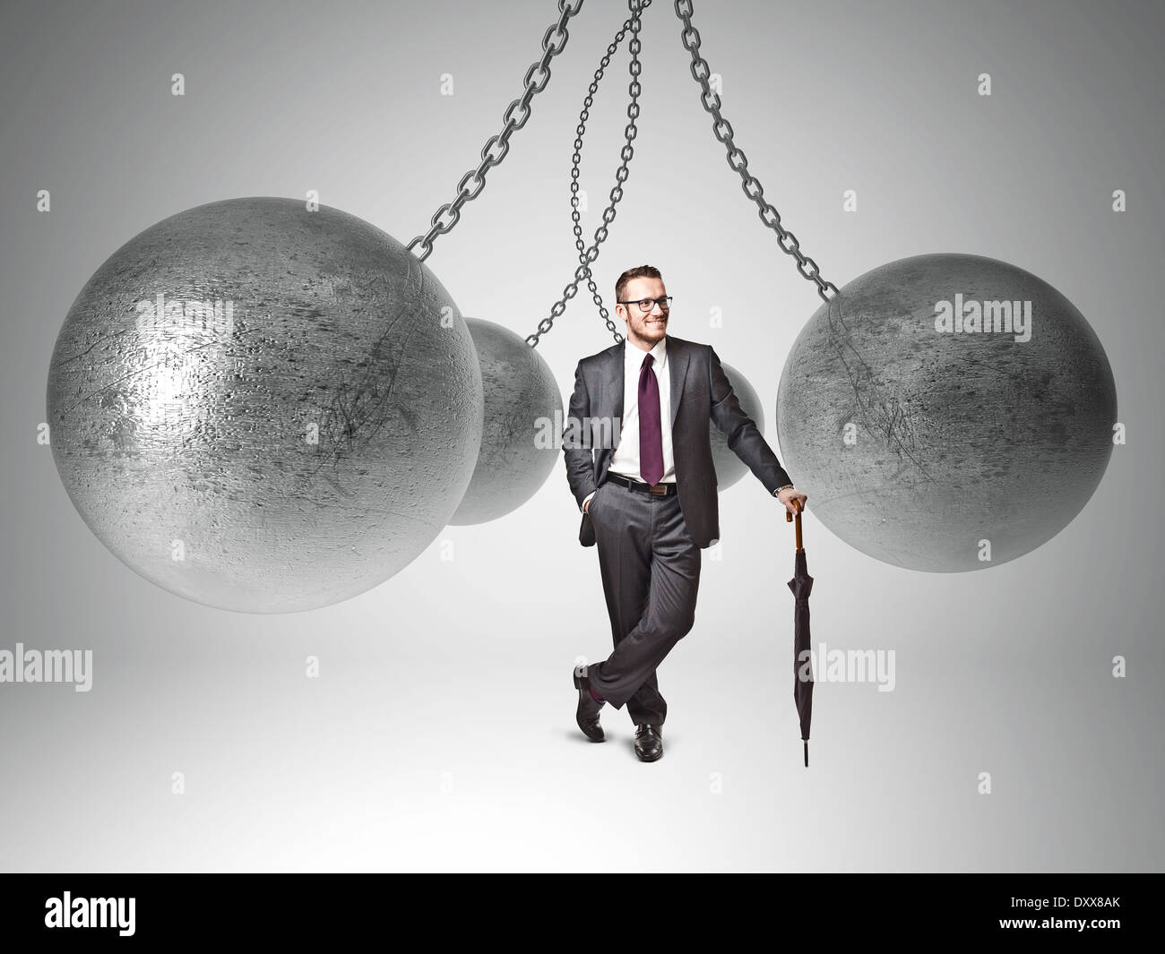 3d image of huge swinging metal ball and businessman Stock Photo - Alamy