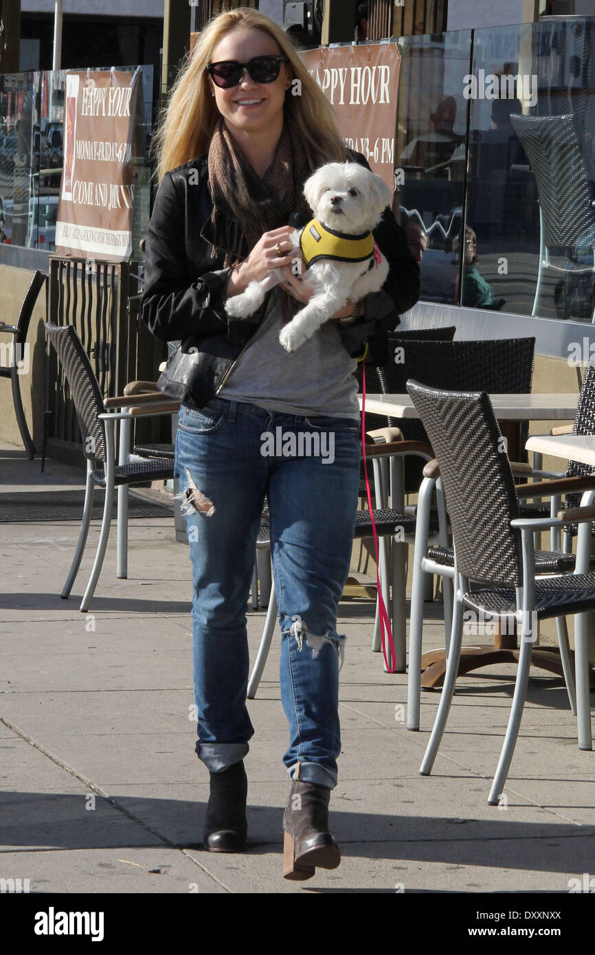 Glee' star Becca Tobin carries her injured dog as she exits Aroma cafe ...