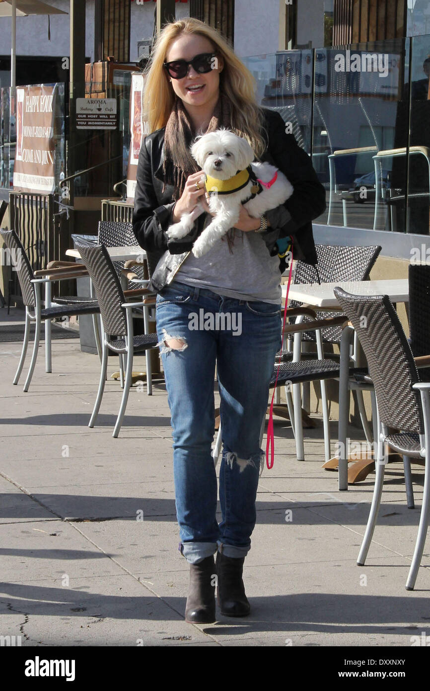 Glee' star Becca Tobin carries her injured dog as she exits Aroma cafe ...