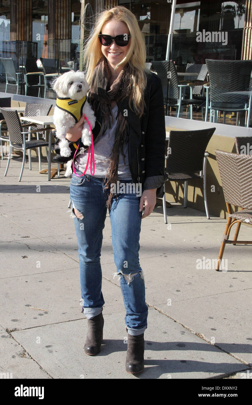Glee' star Becca Tobin carries her injured dog as she exits Aroma cafe ...
