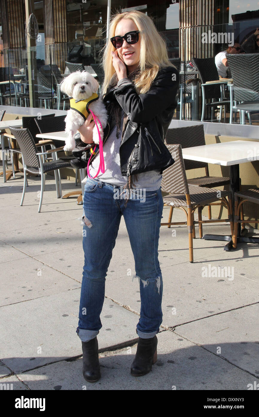 Glee' star Becca Tobin carries her injured dog as she exits Aroma cafe ...