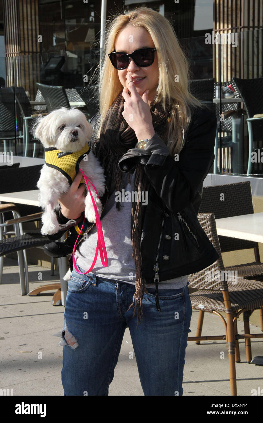 Glee' star Becca Tobin carries her injured dog as she exits Aroma cafe ...