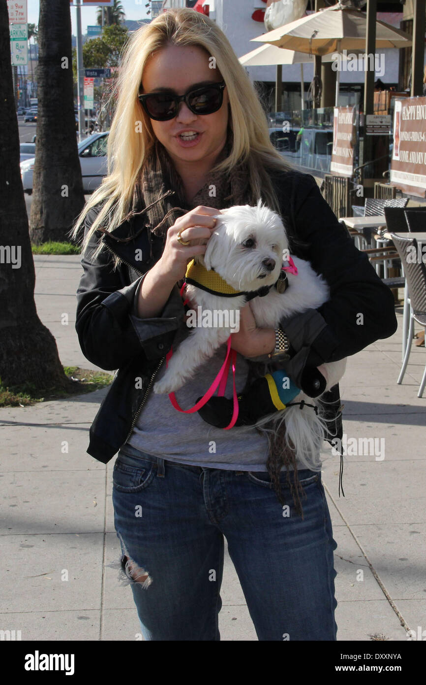 Glee' star Becca Tobin carries her injured dog as she exits Aroma cafe ...