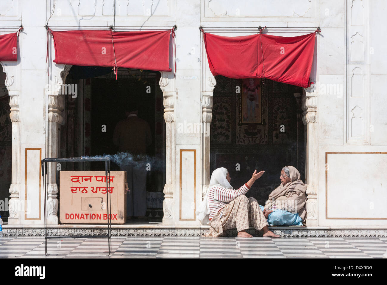 India, Dehradun. Two Women Talking at the Entrance to the Sikh Temple ...