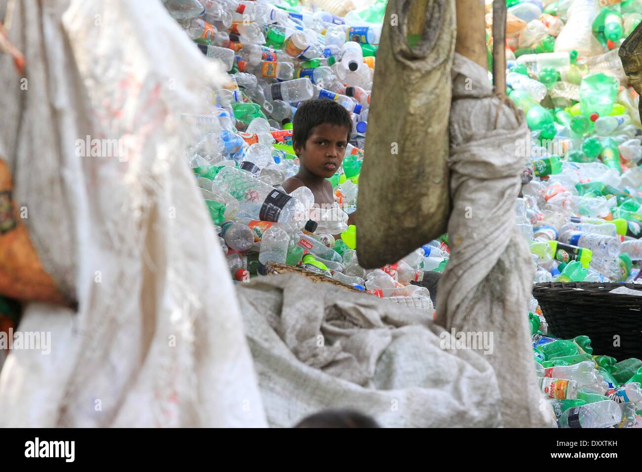 A Bangladeshi children works in a plastic bottle recycling factory ...