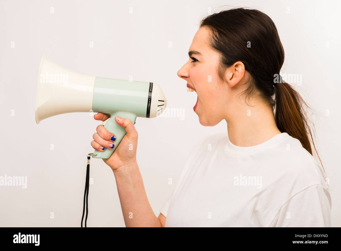 A young attractive slim caucasian woman girl,shouting into a hand held ...