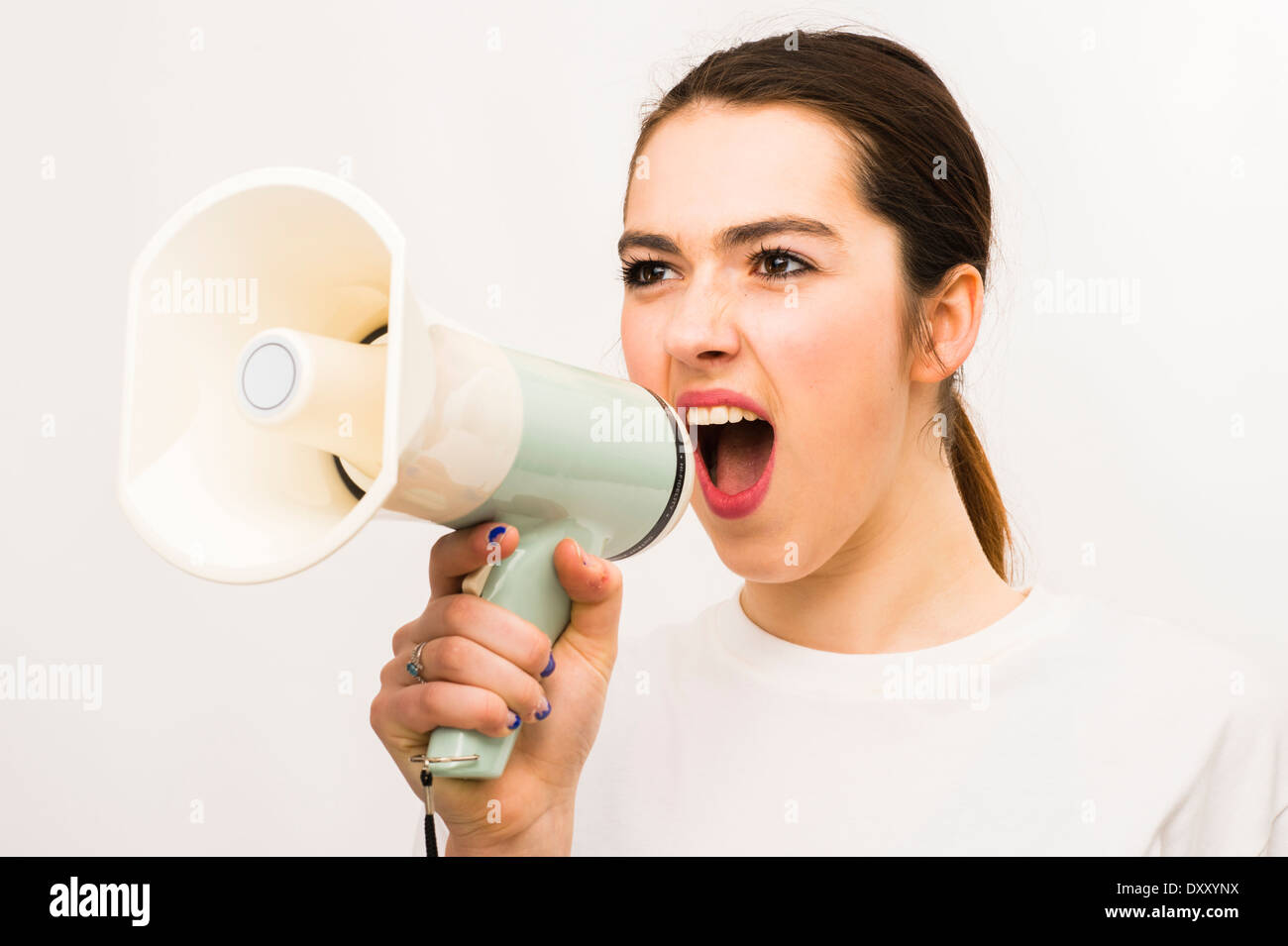 A young attractive slim caucasian woman girl,shouting into a hand held ...