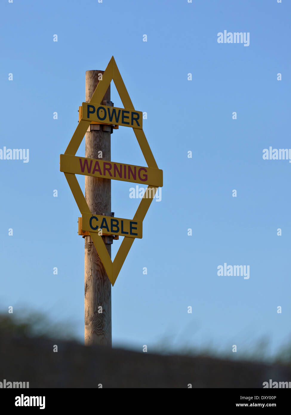 Bright yellow warning sign: power cable Stock Photo - Alamy