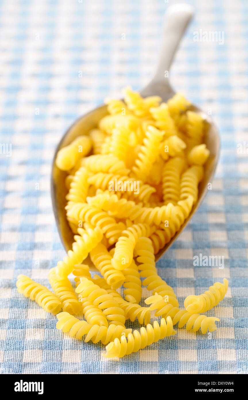Scoopful of twist pasta Stock Photo - Alamy