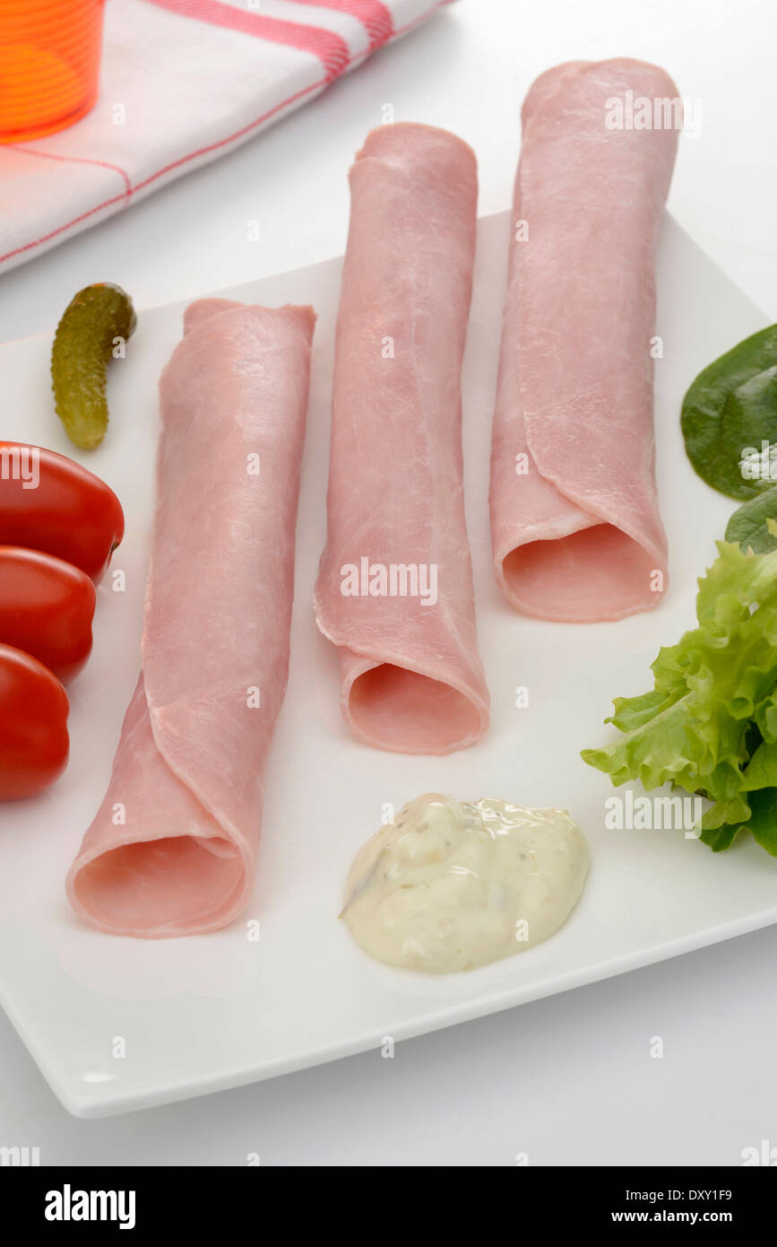 Rolled slices of boiled ham Stock Photo - Alamy
