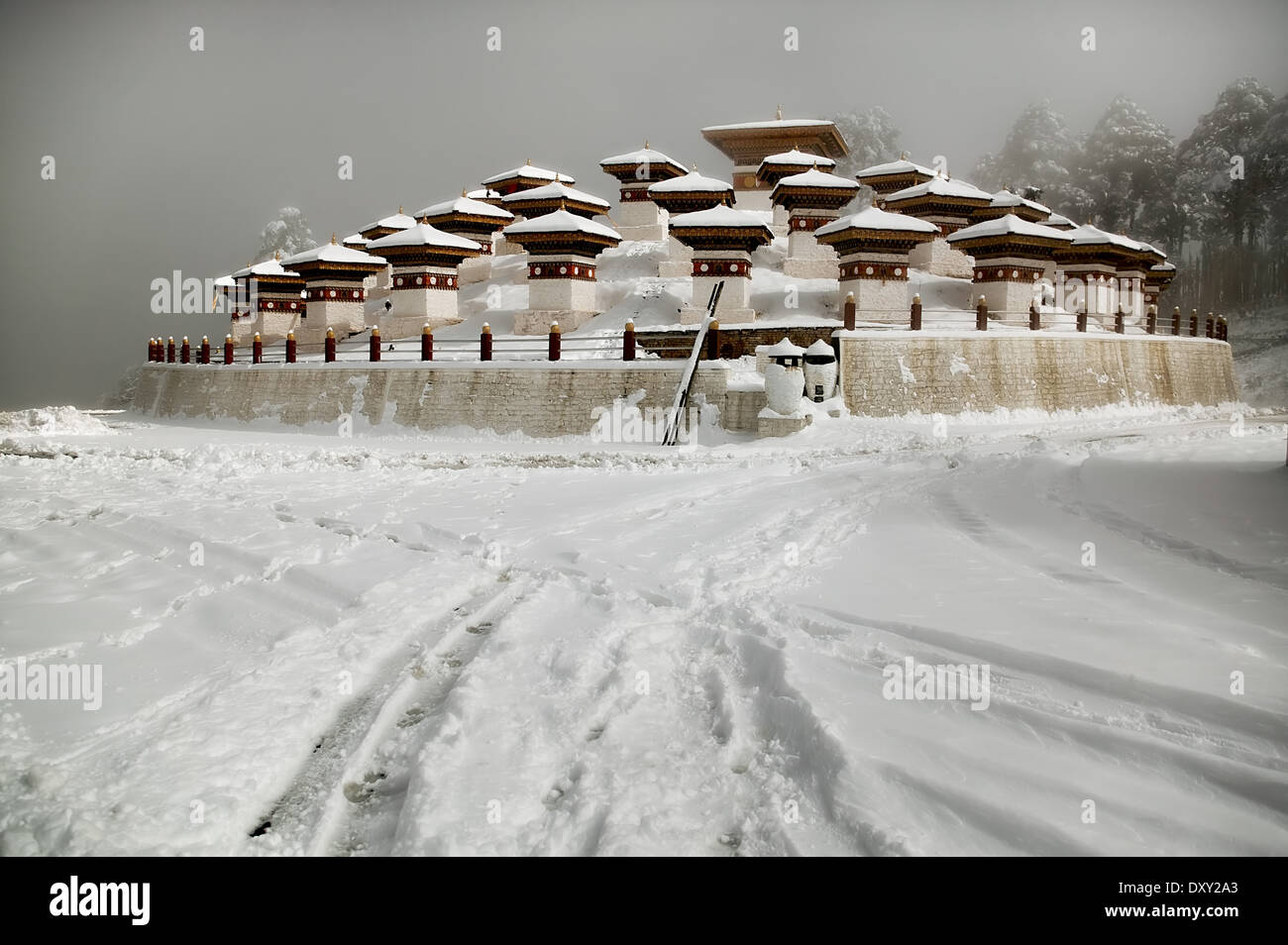 A collection of snow-covered Buddhist stupas at a pass on highway 1 ...