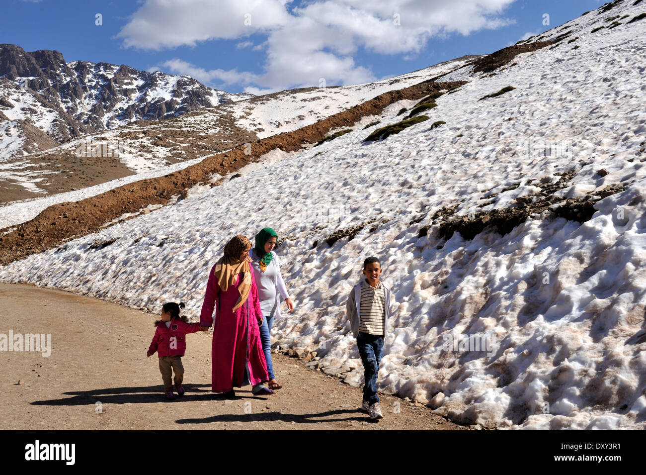 Family walking along snow Atlas mountains Morocco, Oukaimeden, March ...