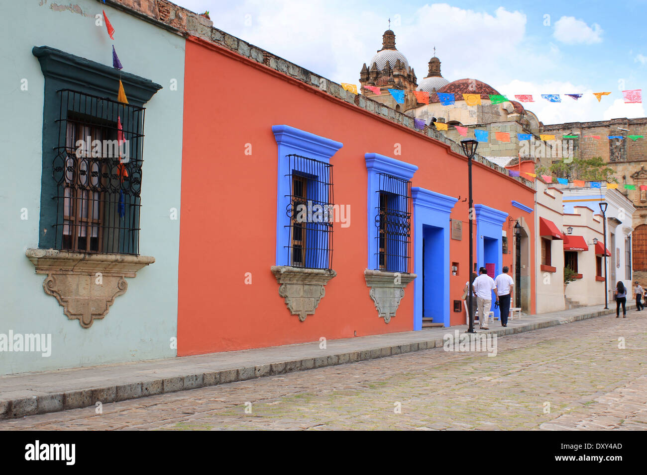 Colourful buildings lining street in Oaxaca with the Church of Santo ...