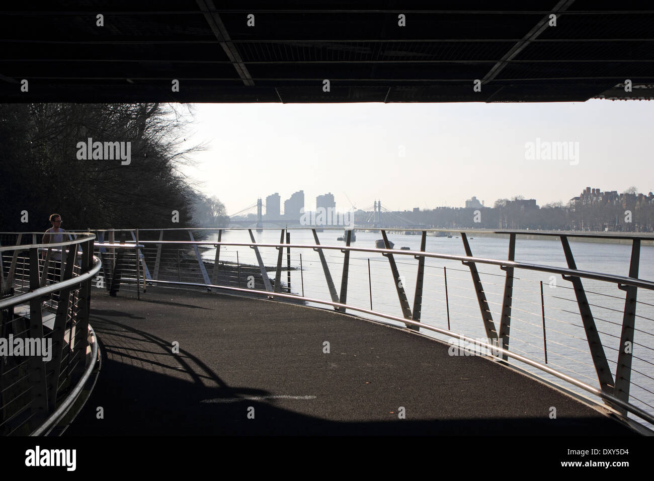 Pedestrian walkway passing under Chelsea Bridge along the River Thames ...