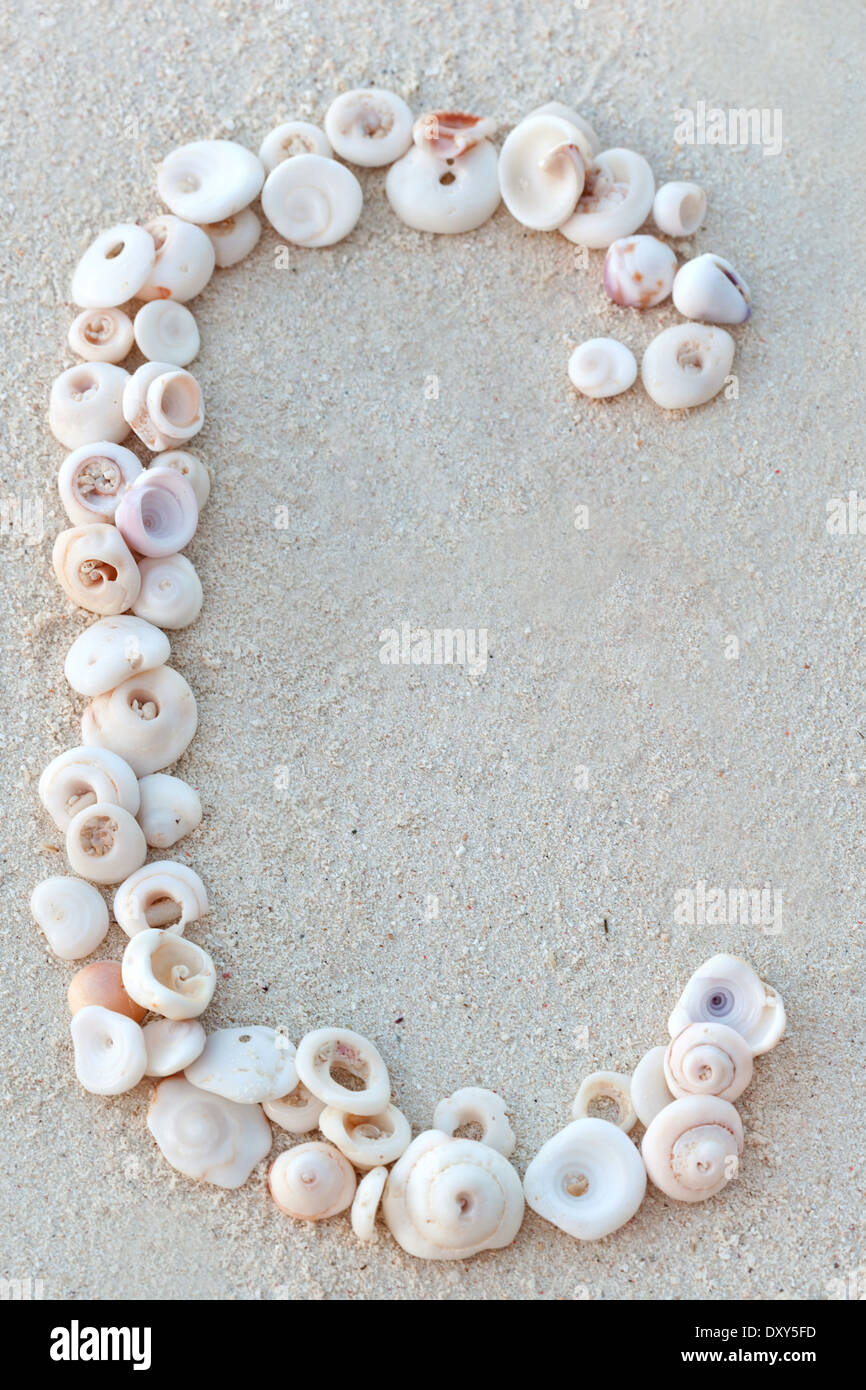 Alphabet shell letters on sandy beach, closeup Stock Photo - Alamy