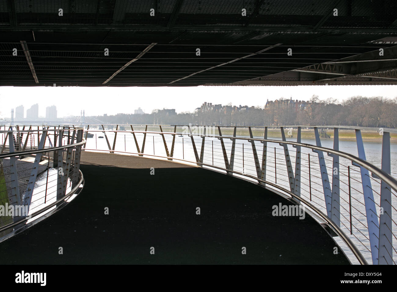 Pedestrian walkway passing under Chelsea Bridge along the River Thames ...