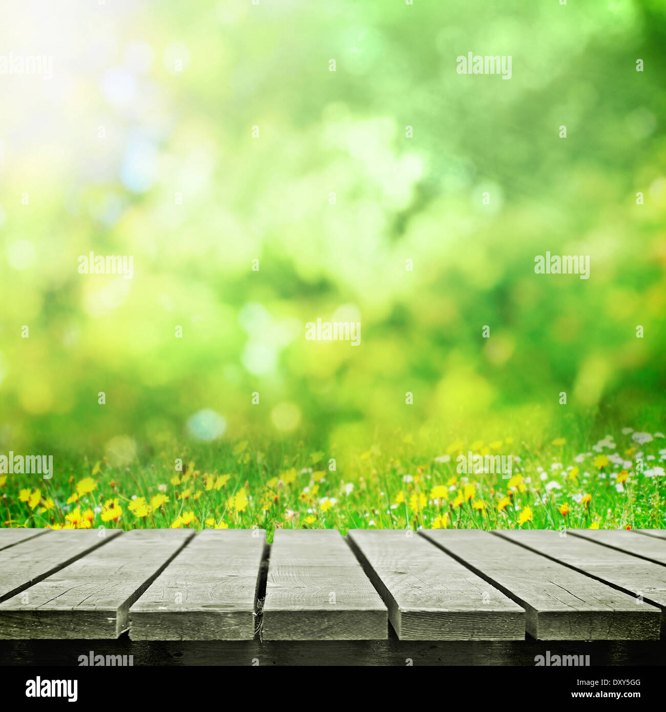 Wooden table near spring meadow Stock Photo - Alamy