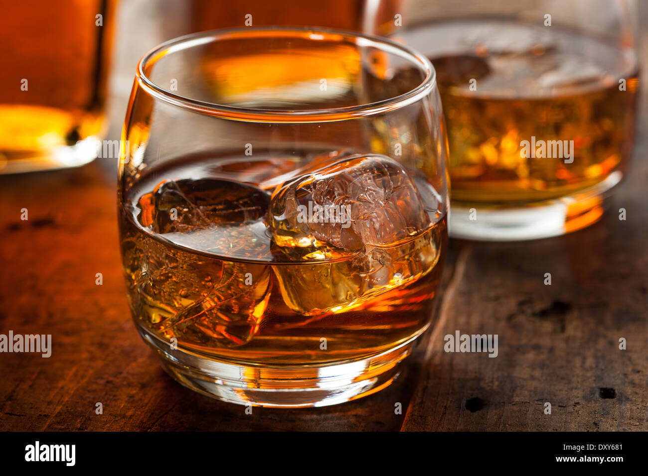 Alcoholic Amber Whiskey Bourbon in a Glass with Ice Stock Photo - Alamy