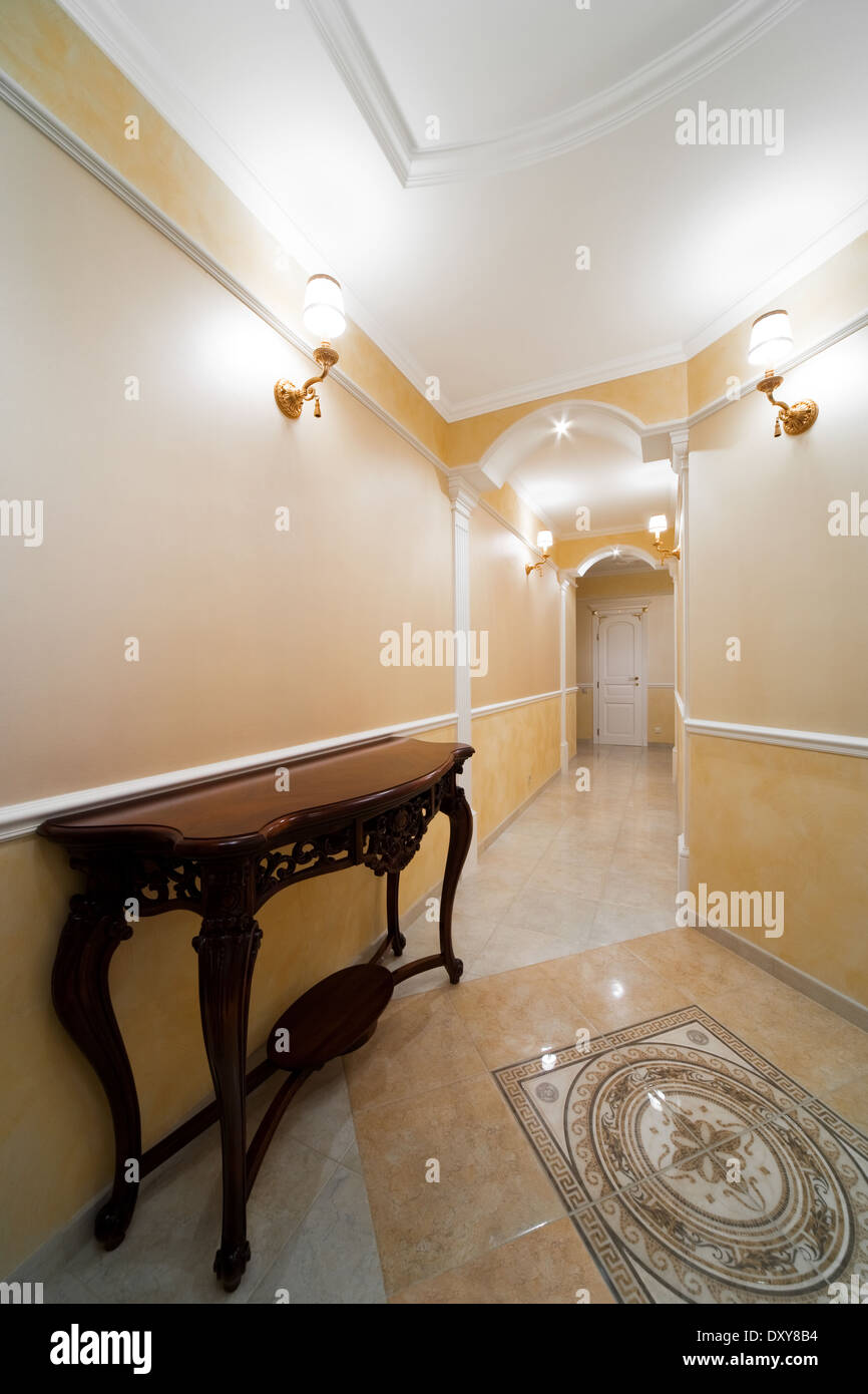 Beautiful table in a light corridor with a door Stock Photo - Alamy