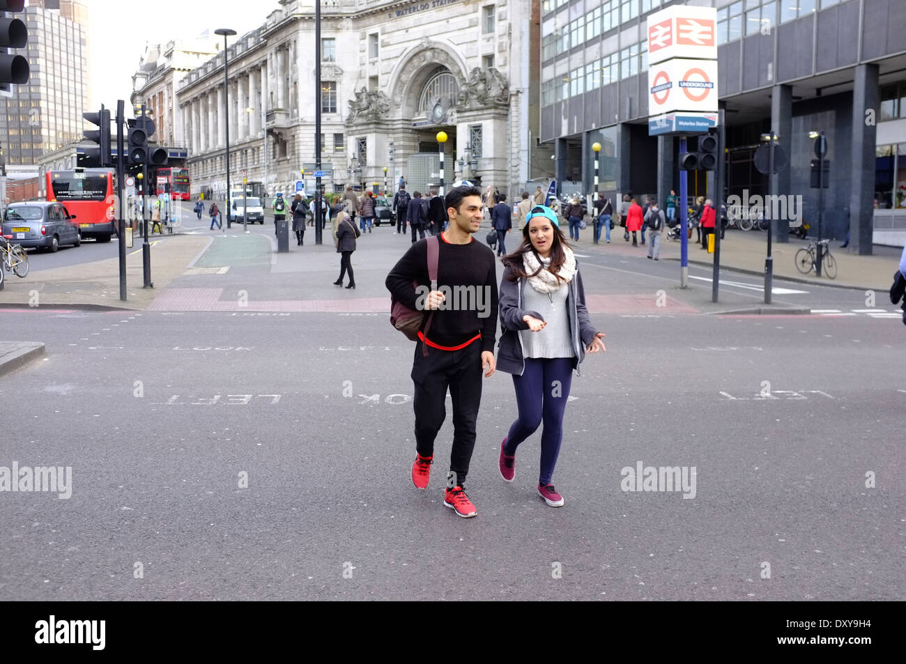 Young man & woman crossing road by Waterloo Railway Station Stock Photo ...