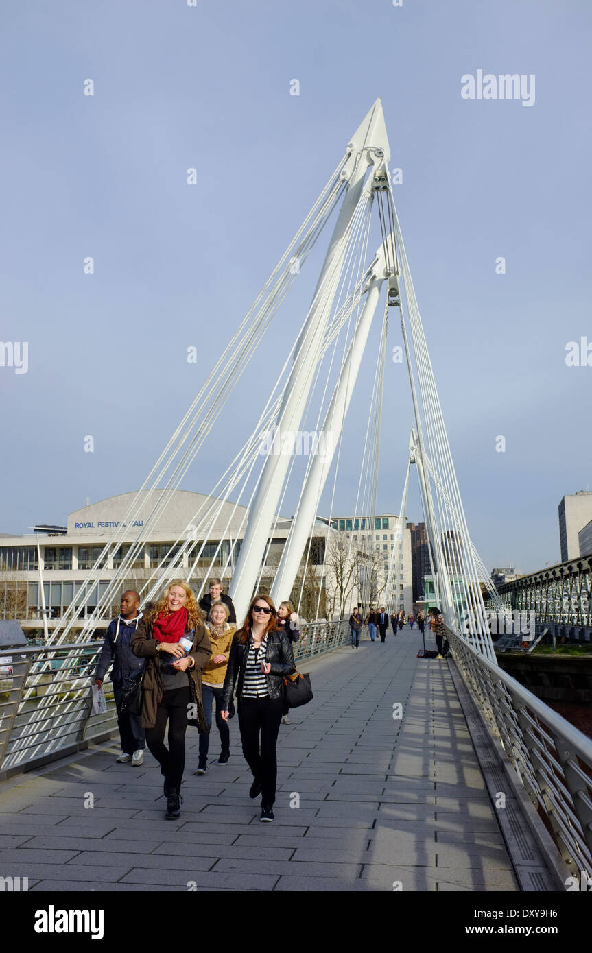 People crossing pedestrian bridge over river Thames, London Stock Photo ...