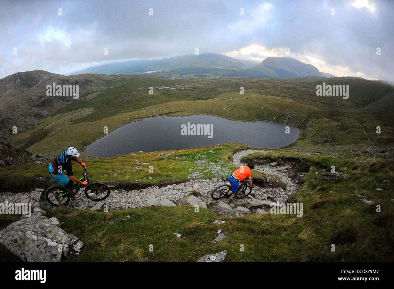 Two mountain bikers ride down the rangers path on mount Snowdon in the ...