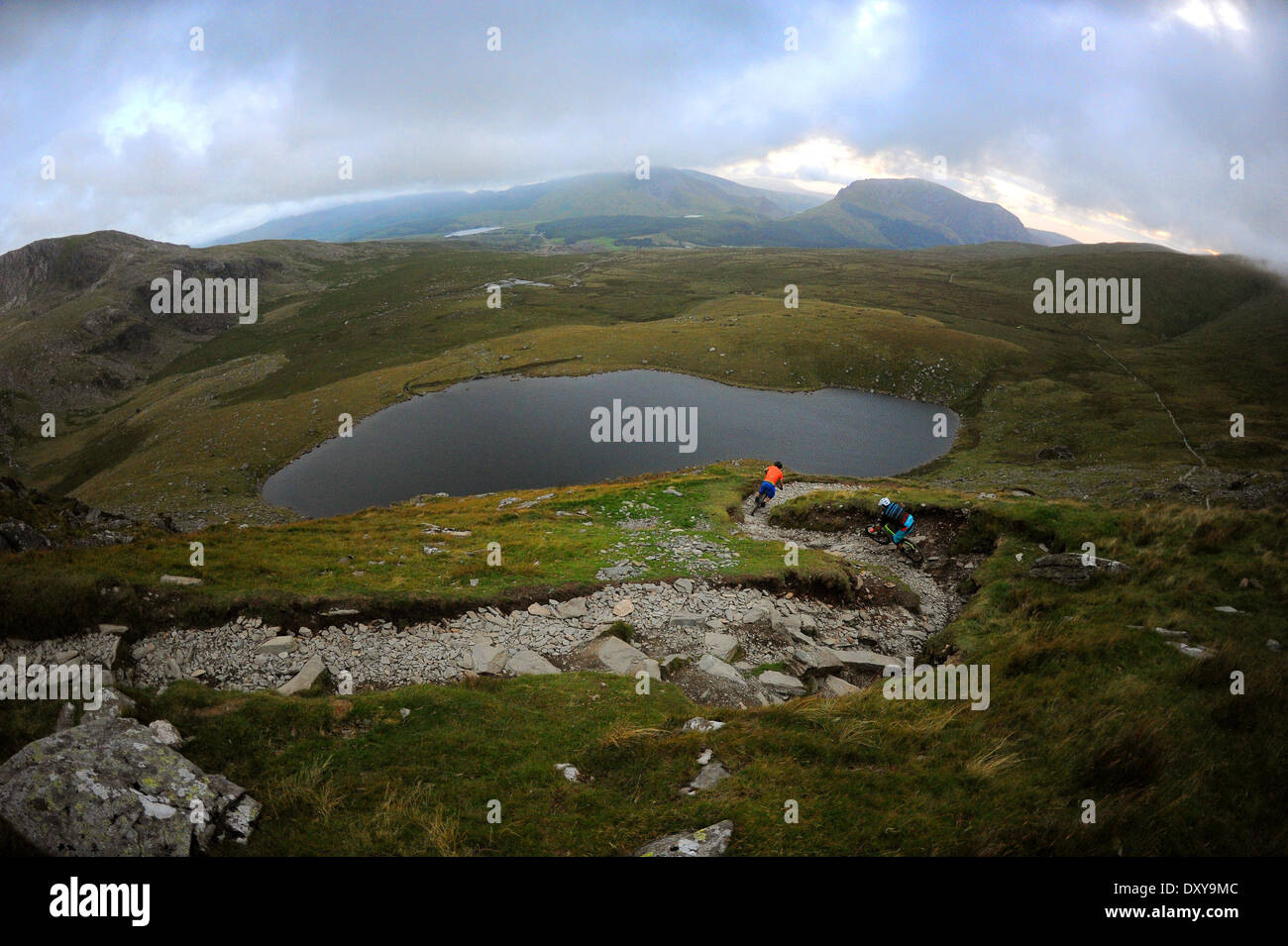 Two mountain bikers ride down the rangers path on mount Snowdon in the ...