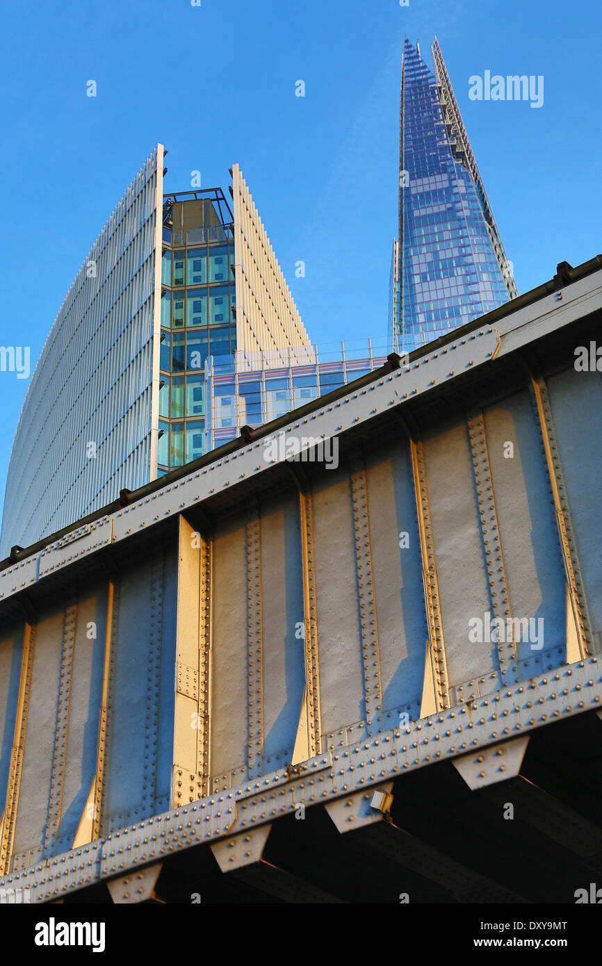 The Shard building and metal railway bridge in London, England Stock ...