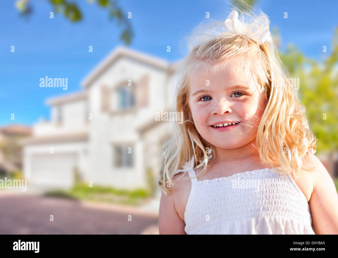 Cute Smiling Girl Playing in Front Yard of House Stock Photo - Alamy