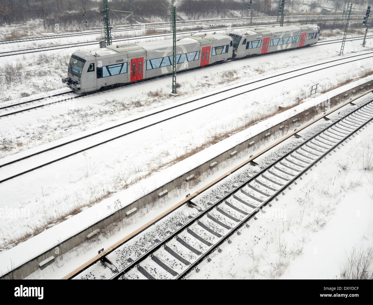 two railroad cars stay on the track under winter snowfall in Germany ...
