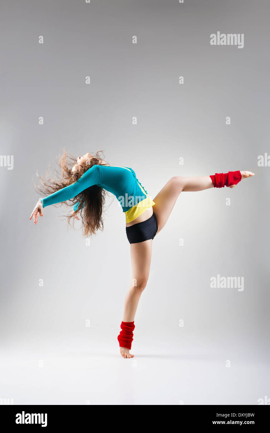 Modern style dancer posing on a studio grey background Stock Photo - Alamy