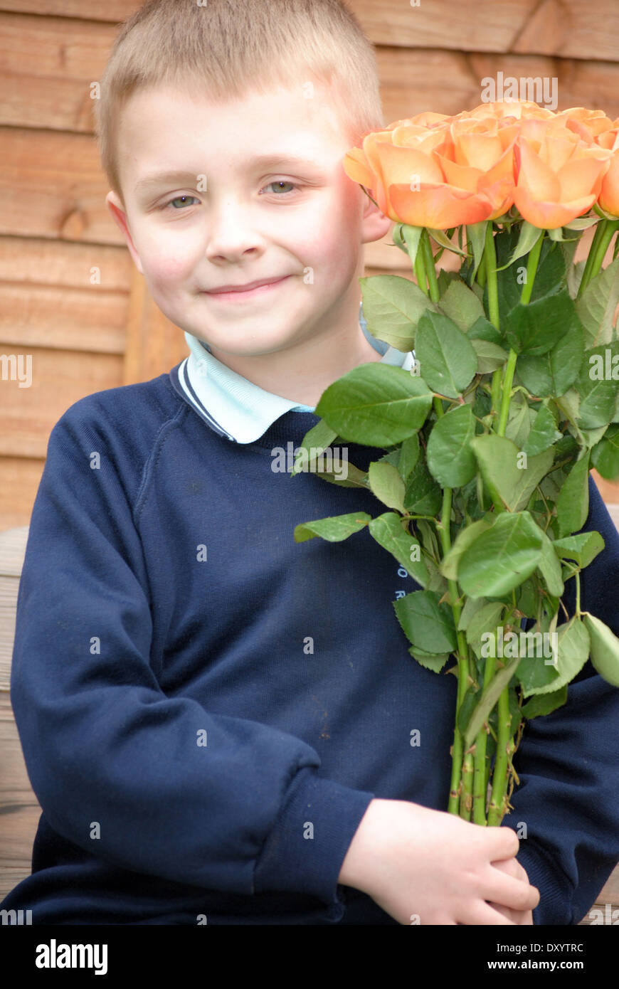 little school boy with flowers Stock Photo - Alamy
