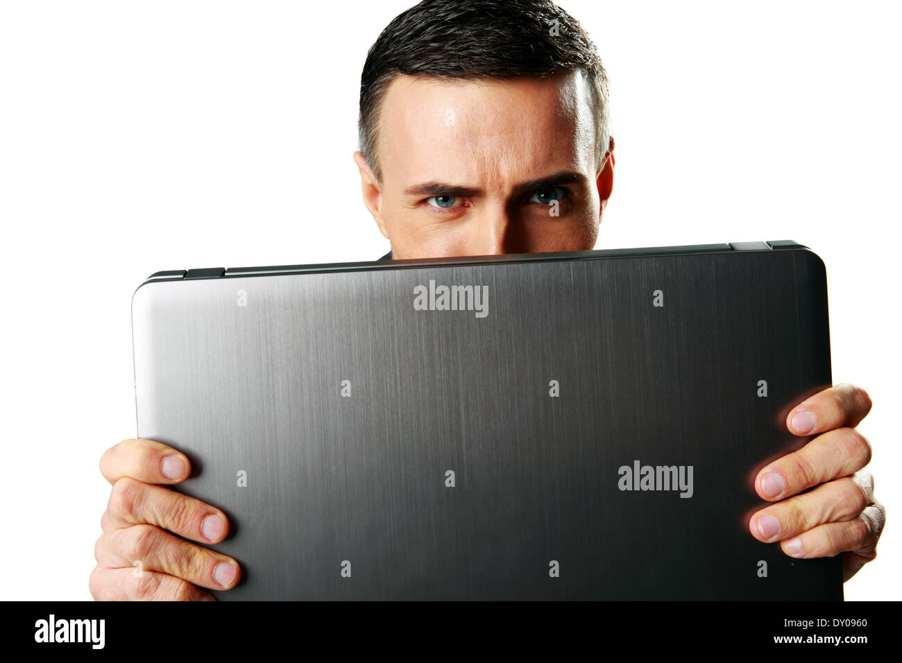 Man hiding behind laptop isolated on a white background Stock Photo - Alamy