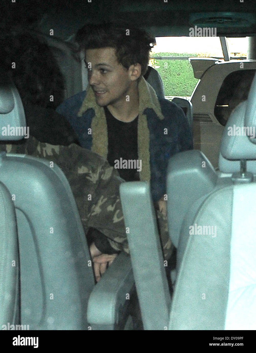 One Direction arrive at a manic Heathrow Terminal 5 holding giant ...