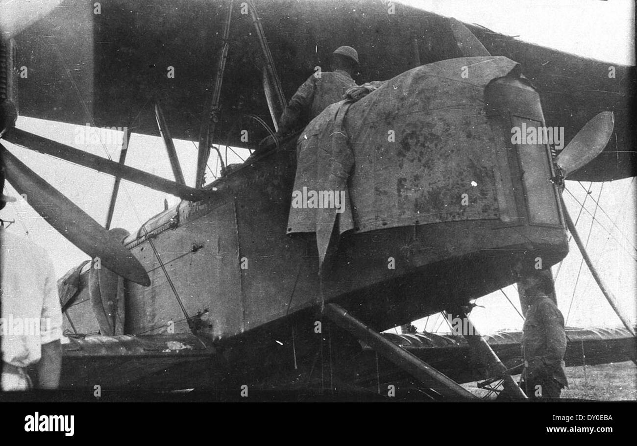 This photograph shows the crew inspecting the fuselage of the aircraft ...