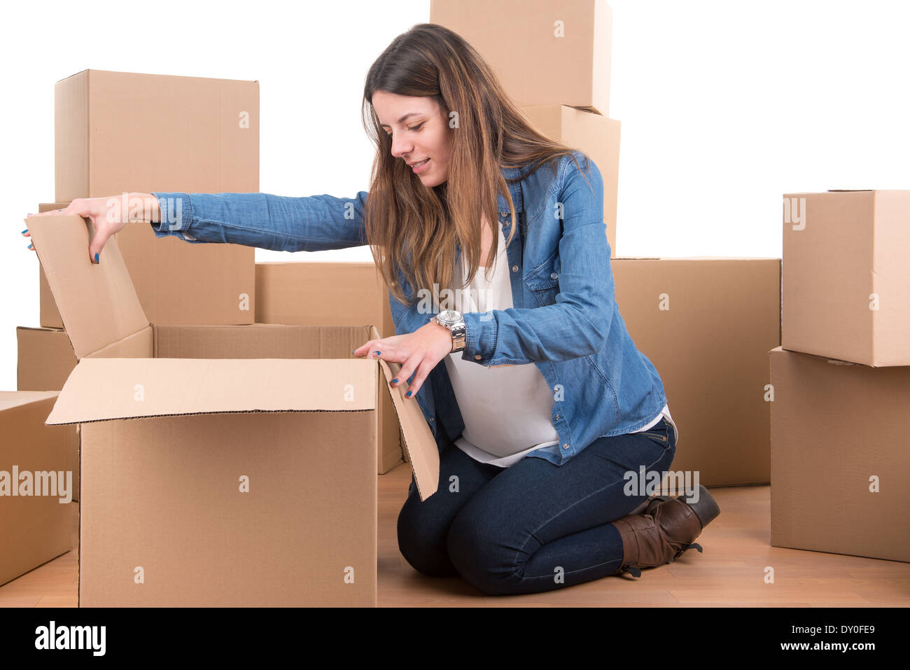 Beautiful girl with cardboard boxes unpacking in new home Stock Photo ...