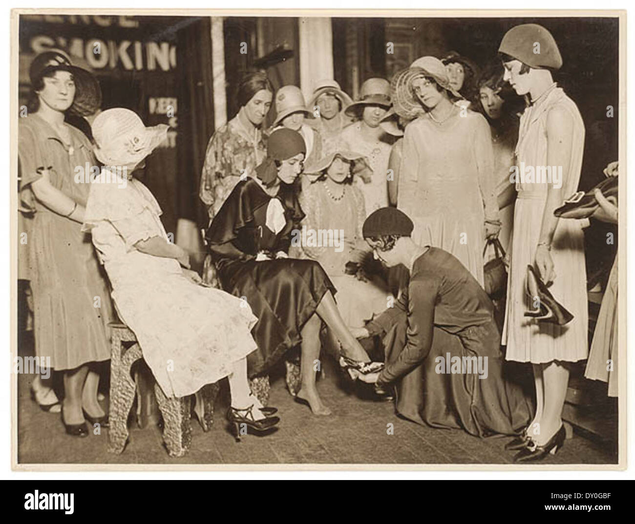 Trying on shoes, ca. 1930 / by Sam Hood Stock Photo - Alamy