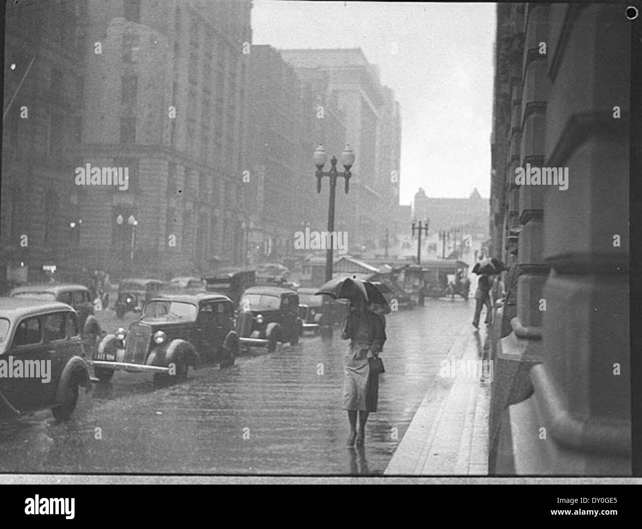 This 1937 photograph by Sam Hood shows a rainy scene in Martin Place ...