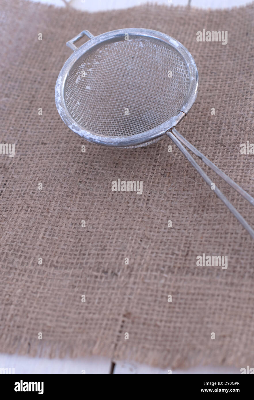 Still life food image of a small sieve on a Hessian background Stock ...