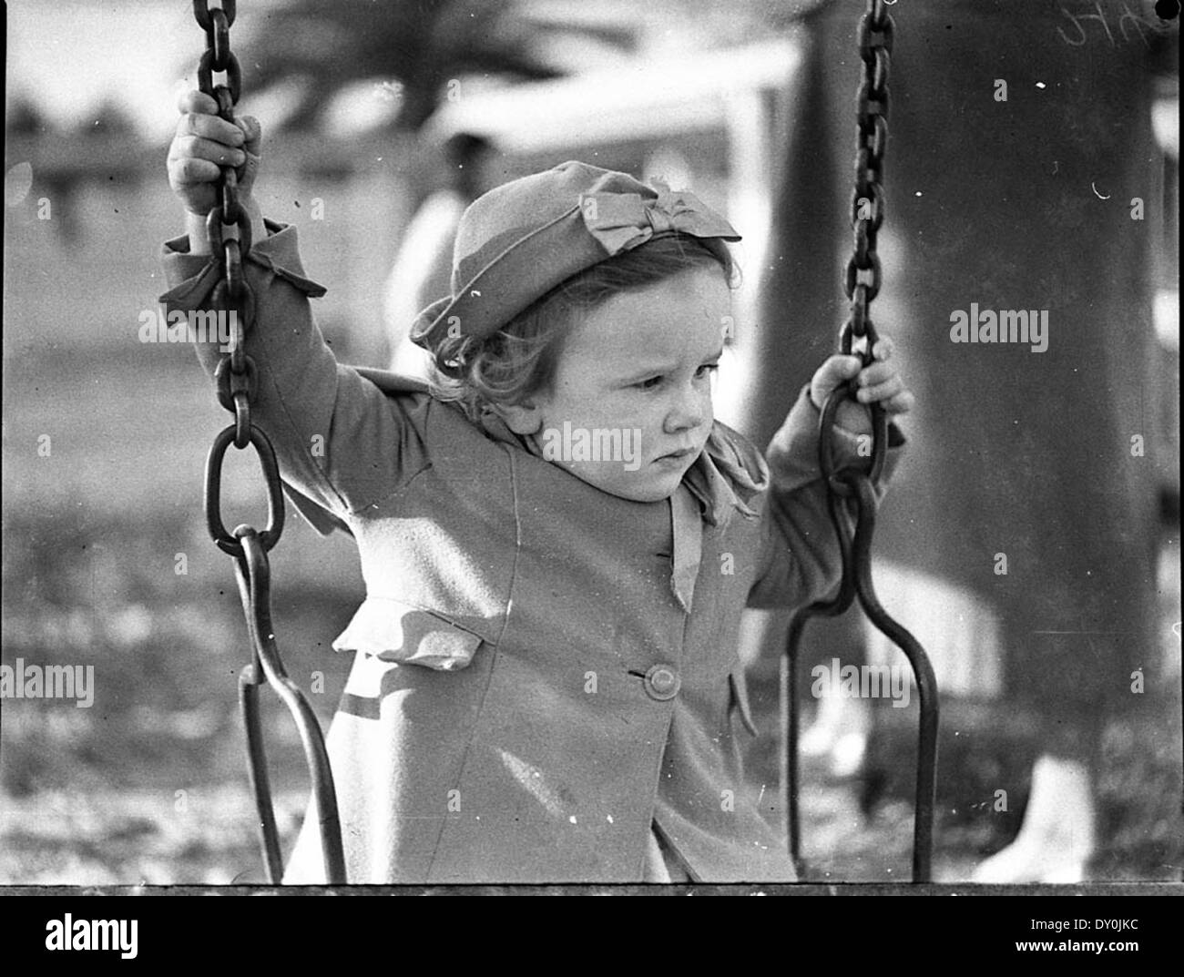 A 1935 photograph by Sam Hood of a young girl on a swing. The image ...