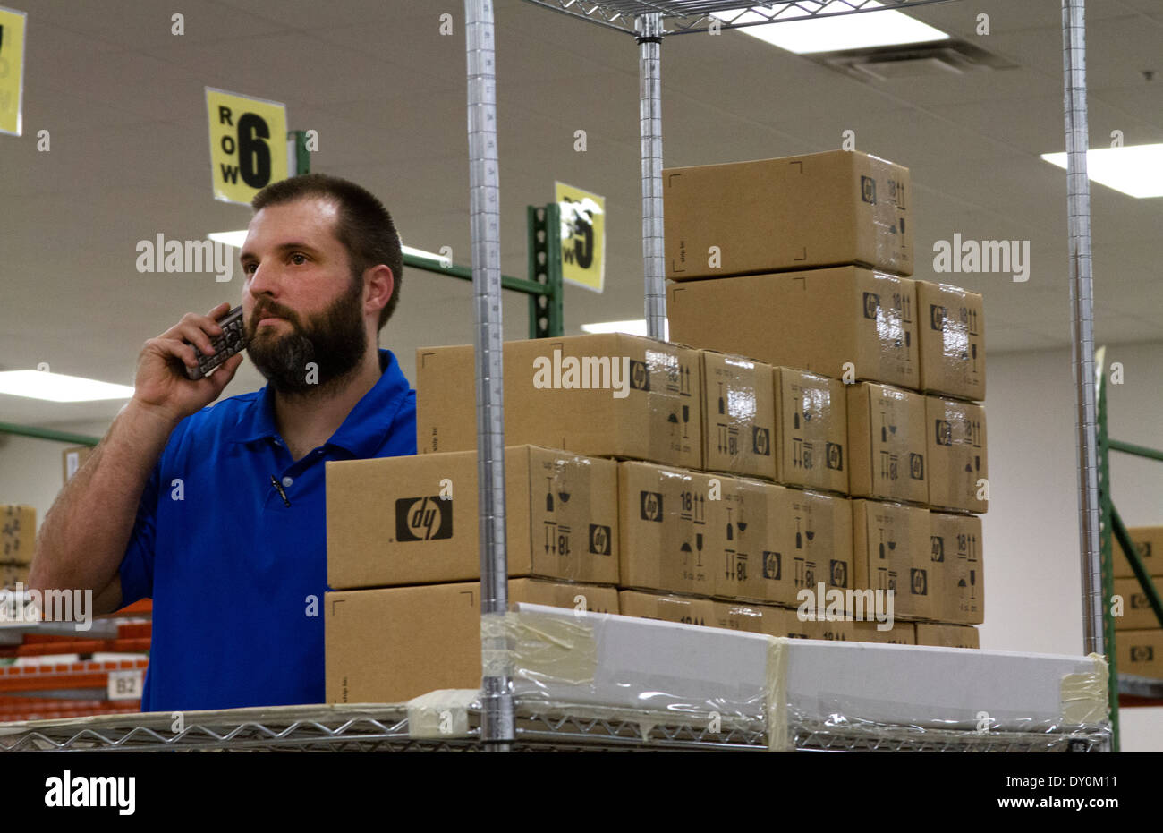 employee talking on phone while working in warehouse with boxes Stock ...